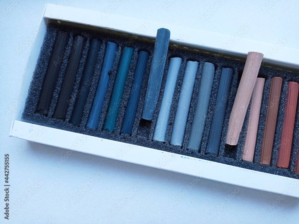 Pastel drawing pencils in a box. A drawing kit. Artist, hobby, drawing ...