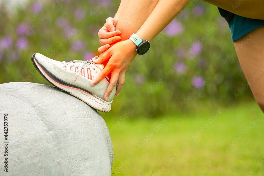 Sport woman has sore ankle from exercising training. It is a common ...