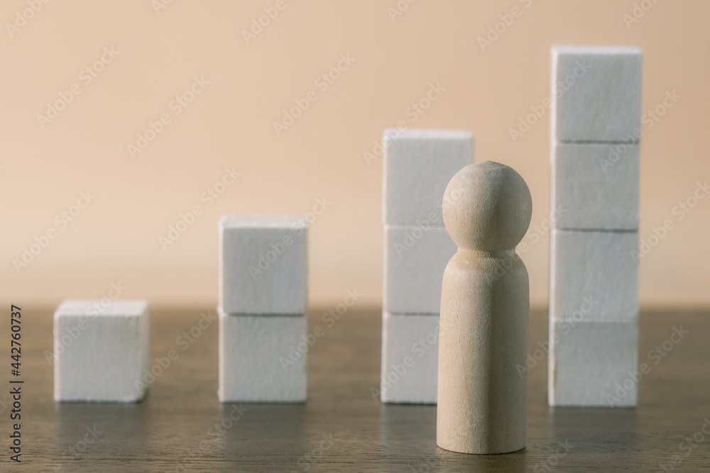 Figurine of a man stands aside from the crowd of people. Asociality ...