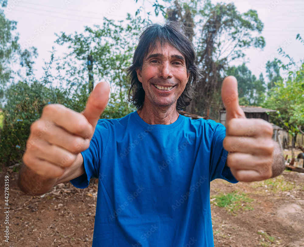 Latin man of indigenous descent on his farm. Brazilian farmer. Thumbs ...