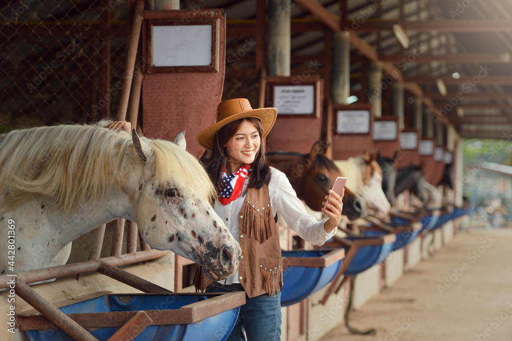 Cowgirl working stables.Concept of retro woman in horse ranch Stock ...
