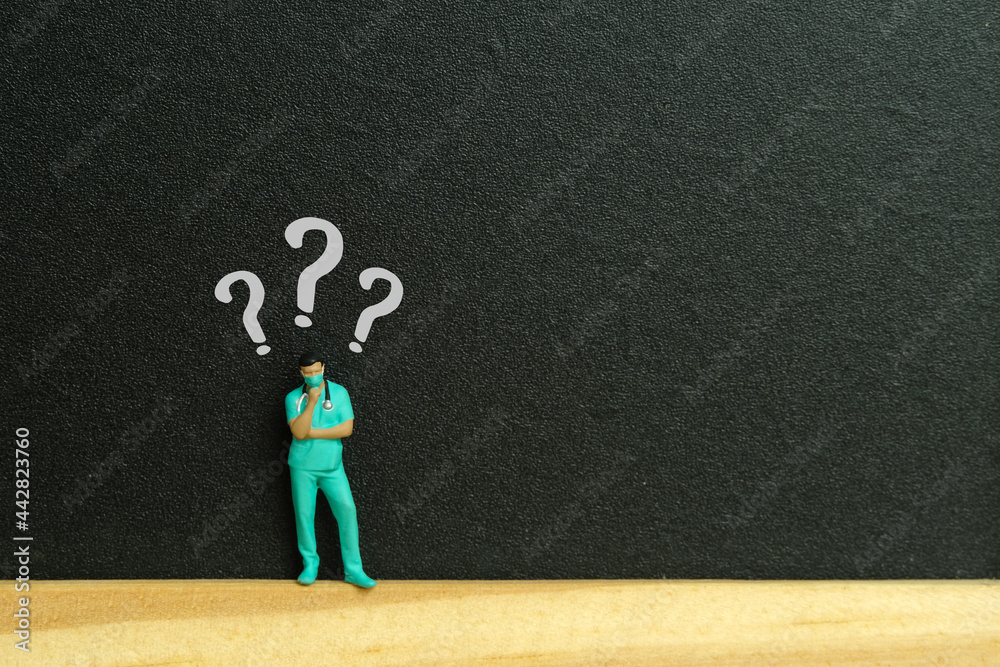 Miniature people toy figure photography. A men doctor or nurse thinking ...