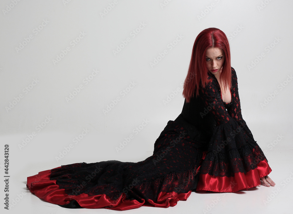 full length portrait of red haired woman wearing long black gothic ...