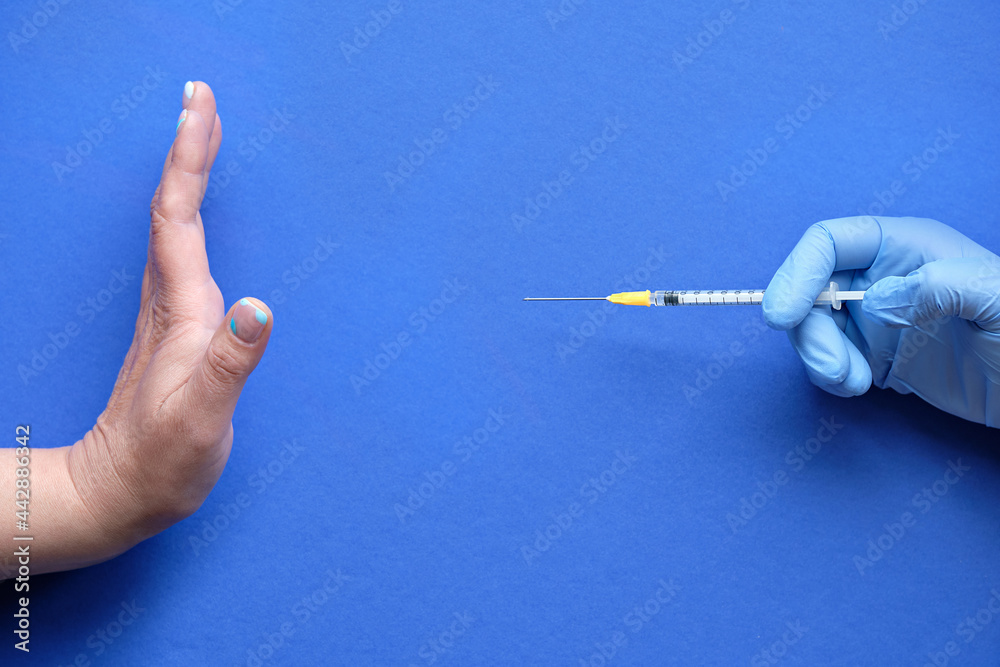 Vaccine refusal concept. Medic hand in glove with syringe. Hand ...