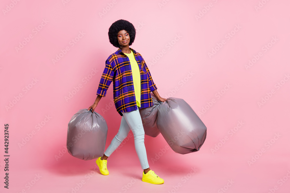 Full length body size view of attractive cheerful girl carrying waste ...