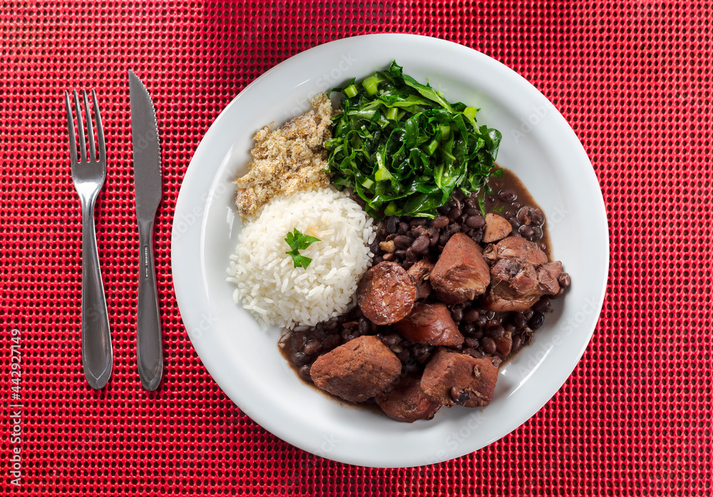 Traditional Brazilian feijoada food from above on a red table Stock ...