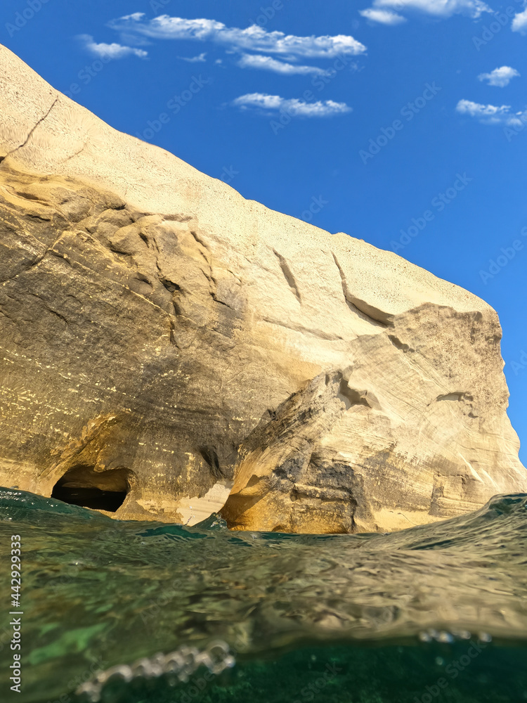 Underwater sea level split photo of iconic caves of Sarakiniko a ...