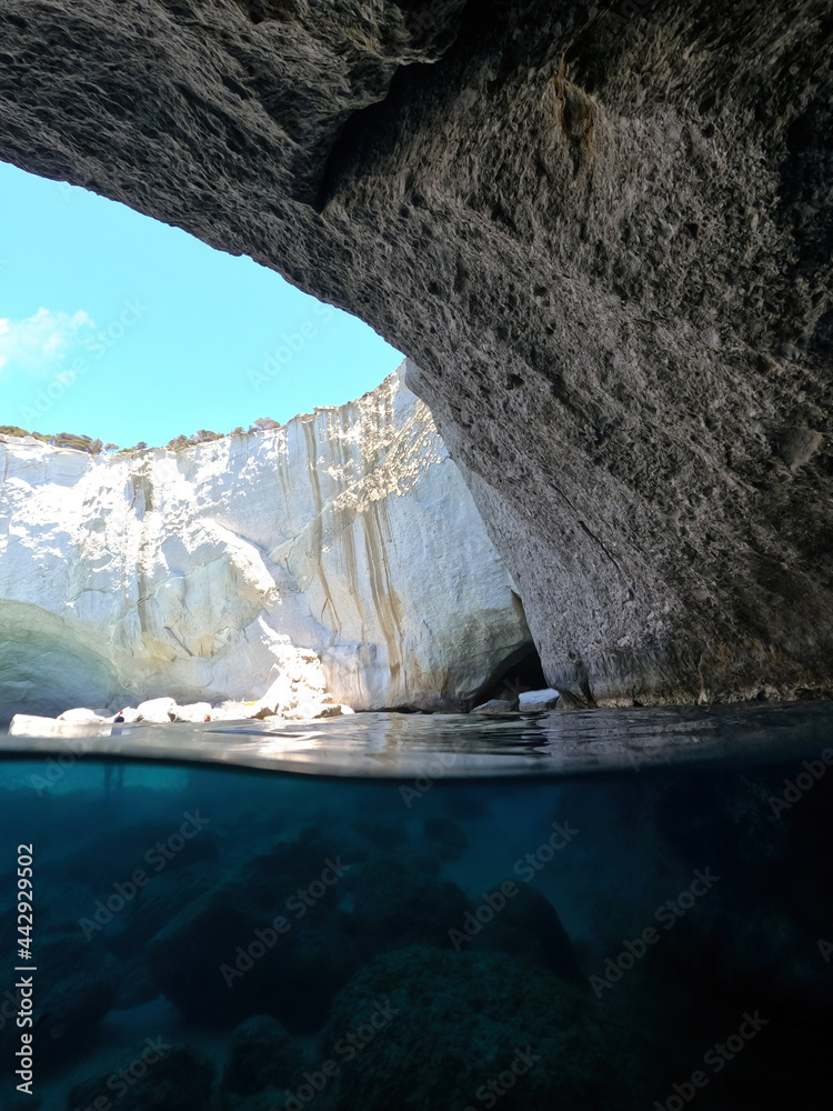 Underwater split photo of caves in Kleftiko, a beautiful scenic white ...