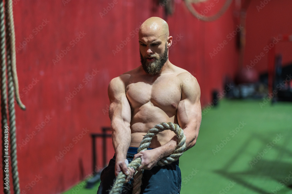 Powerful athlete pulling heavy weights Stock Photo | Adobe Stock
