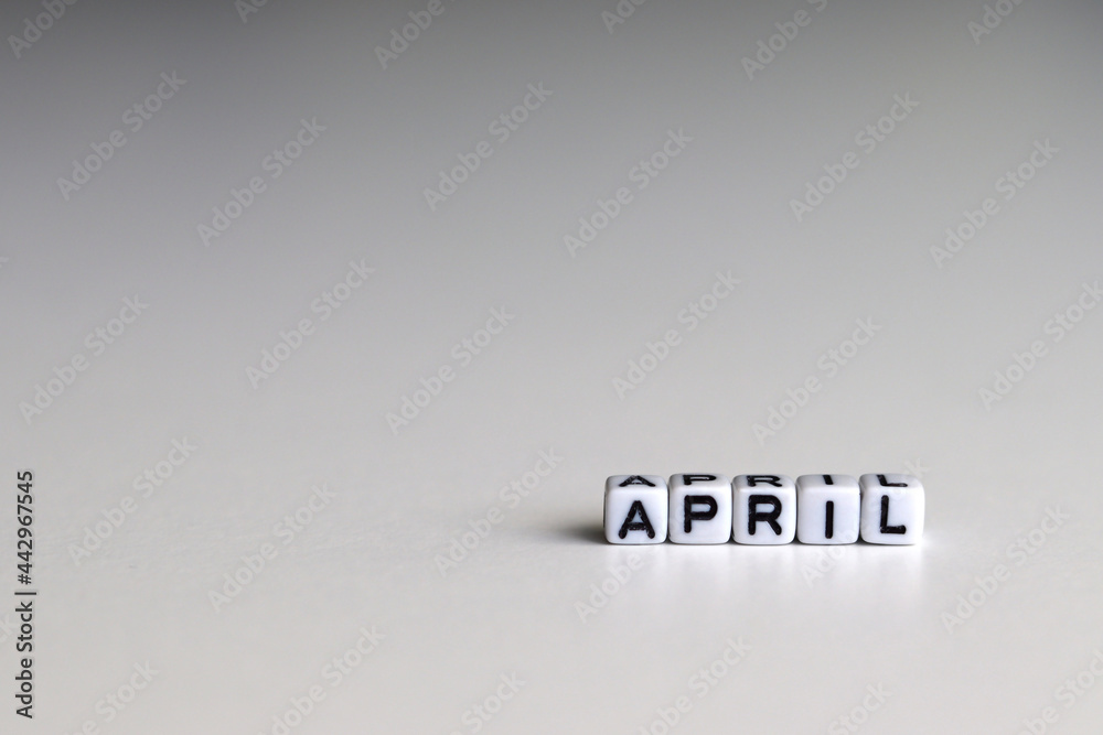 Stockfoto APRIL text on white cubic blocks. The letters are written on ...