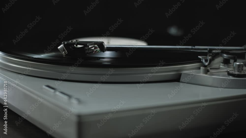 Vintage vinyl disc player (lps). A man's hand presses the start button ...