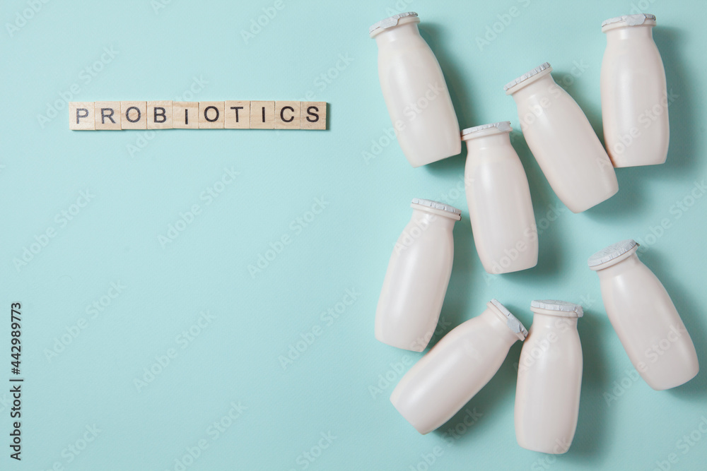 Bottles with probiotics and prebiotics dairy drink on light blue ...