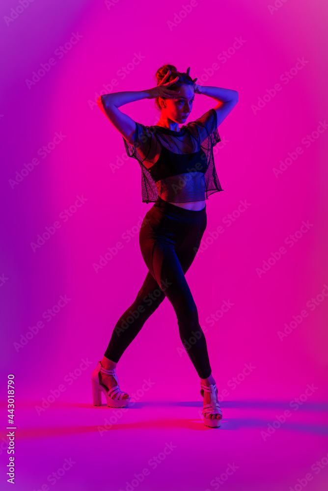 Beautiful female dancer wearing black and high heels while performing ...