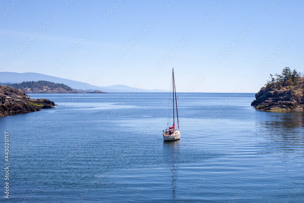 A sailboat is anchored (moored) in a small cove on the southern end of ...