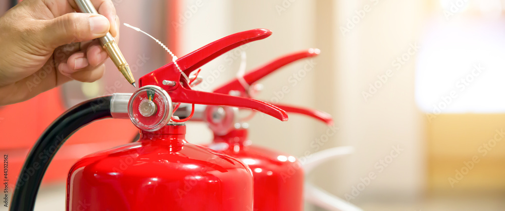 Fire extinguisher, Firefighter checking pressure gauge level of fire ...