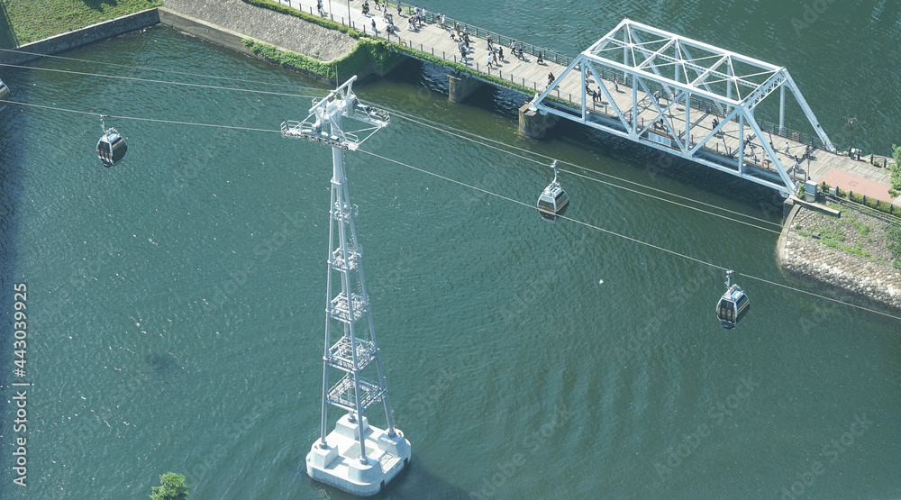 Japanese ropeway and river footbridge on a clear day with overhead view ...