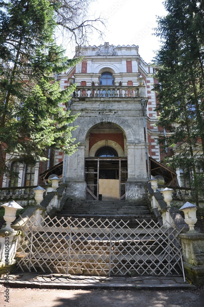 The overgrown and abandoned facade of the manor house of a noble estate ...