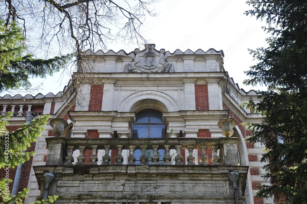 The overgrown and abandoned facade of the manor house of a noble estate ...
