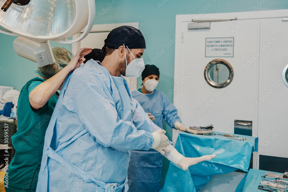 Medical doctors preparing for surgical operation inside modern hospital ...