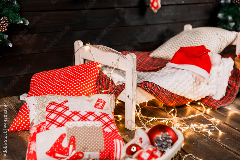 Christmas themed bedroom with small bed, Santa Claus hat. Wooden ...