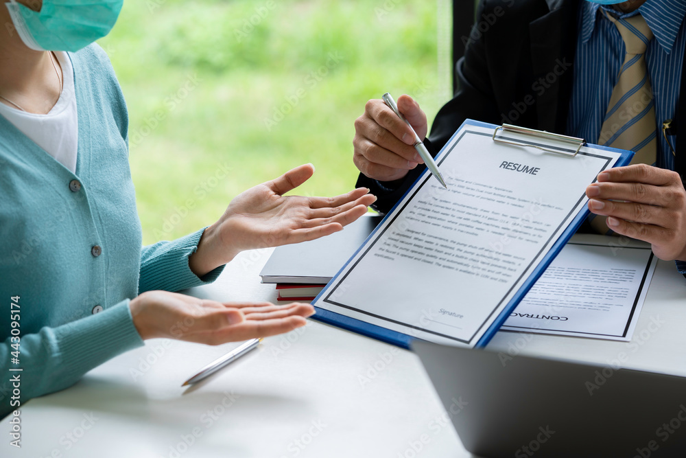 Human resources manager conducting job interview with applicant in the ...