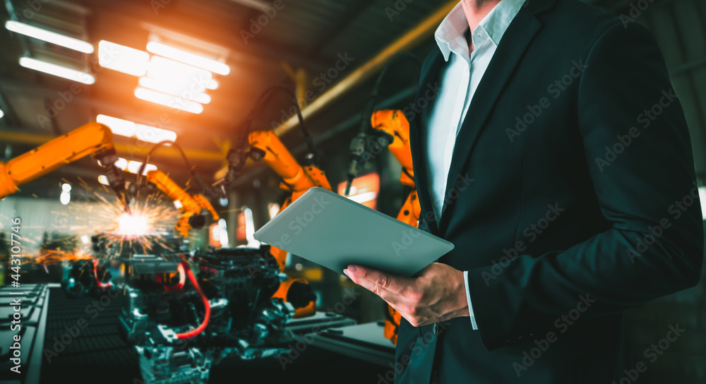 Engineer use advanced robotic software to control industry robot arm in ...