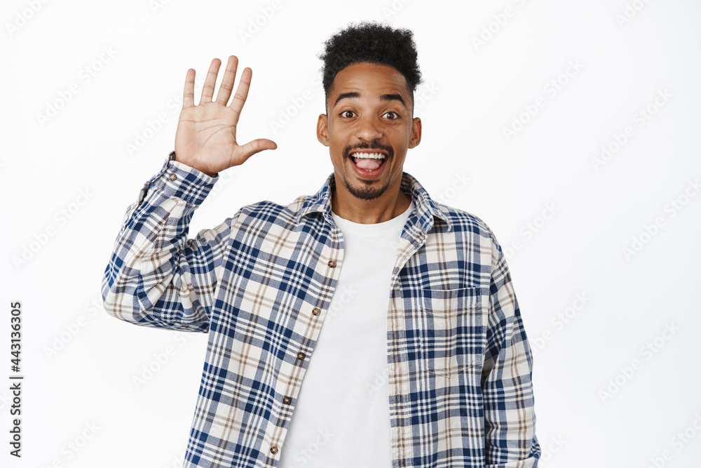 Friendly and cheerful african american man wave hand, smiling happy and ...