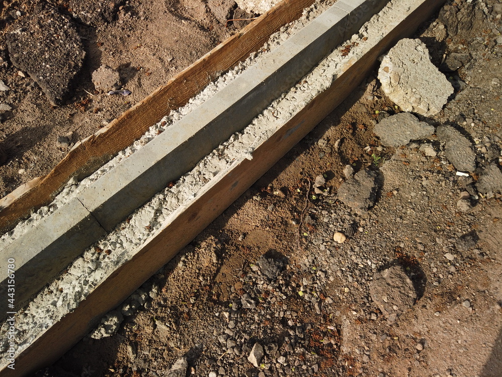 Road reconstruction. New curbstone installed and fixed with concrete ...