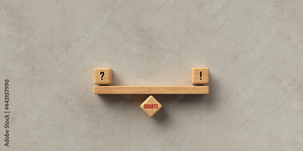 cubes forming a wooden scale balancing a question mark and an ...