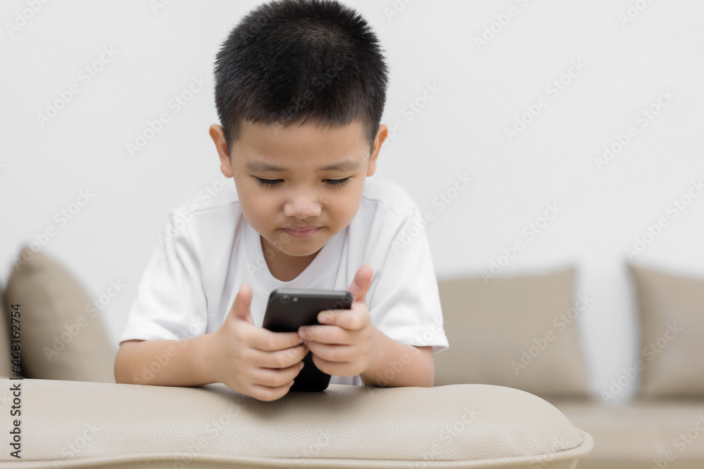 Happy little boy having fun playing game on mobile phone, Preschool kid ...
