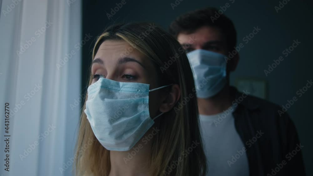 Sad couple wearing protective medical mask on face, man and woman ...