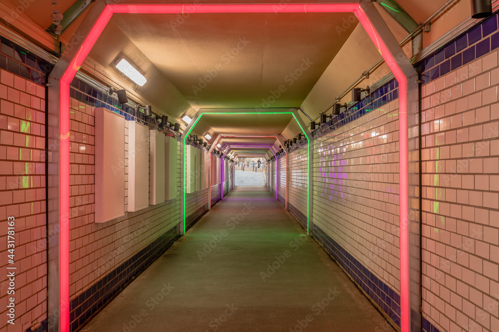 Pedestrian underpass lit with arches of colored lights. Stock Photo ...