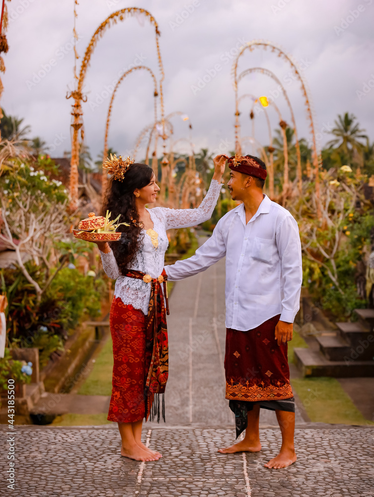 Balinese ceremony. Multicultural couple going to Hindu religious ...