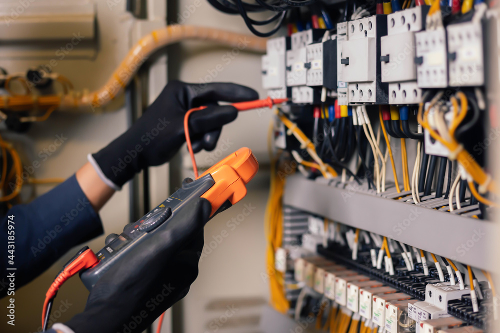 Electrician engineer work tester measuring voltage and current of power ...