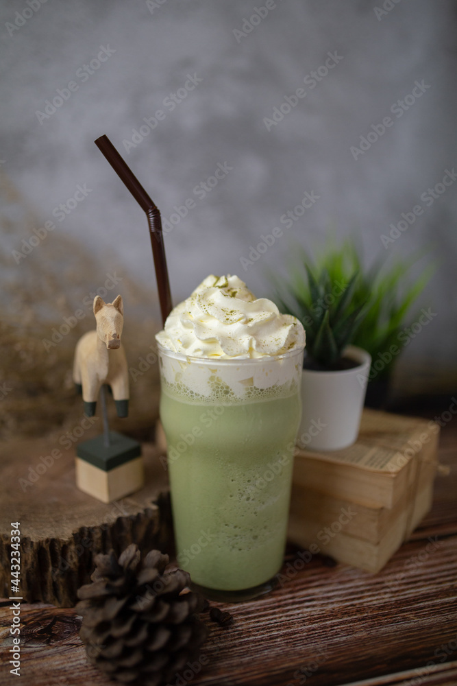 Fresh milk green tea menu is placed on a wooden table. The background ...