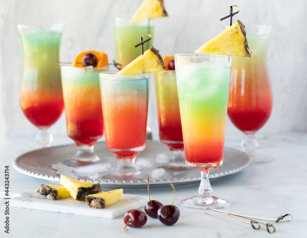 A tray of colourful mocktails with one out in front, ready for drinking ...