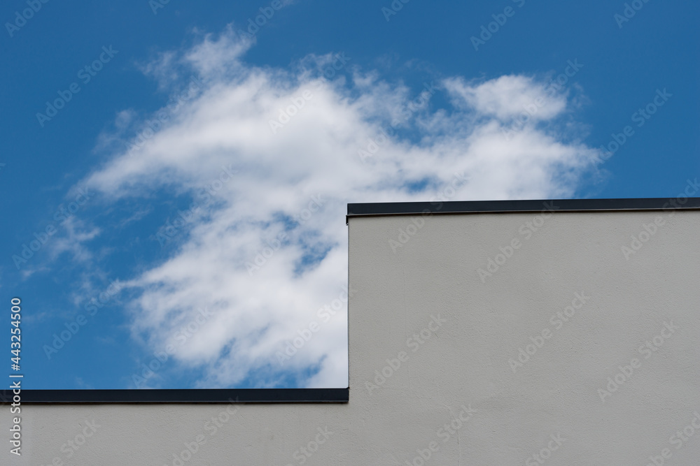 nondescript stucco walled building against blue sky with clouds Stock ...