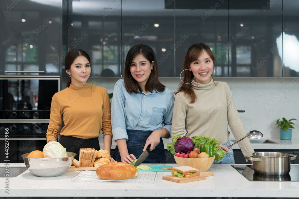 Portrait of attractive Asian woman holding fresh fruit and vegetables ...