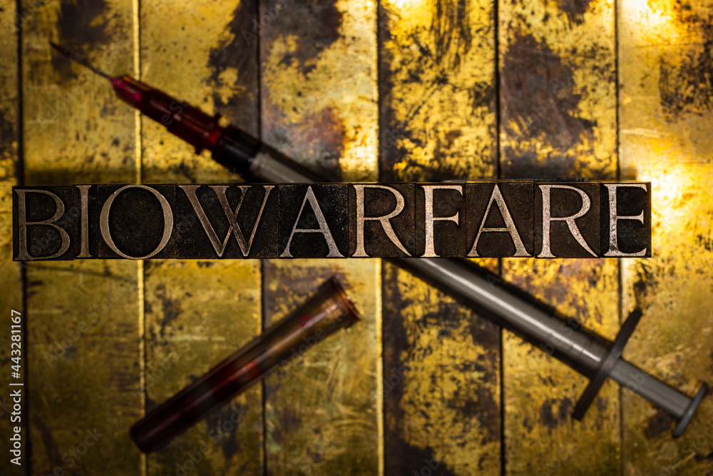 Biowarfare text with syringe on grunge textured copper and gold ...