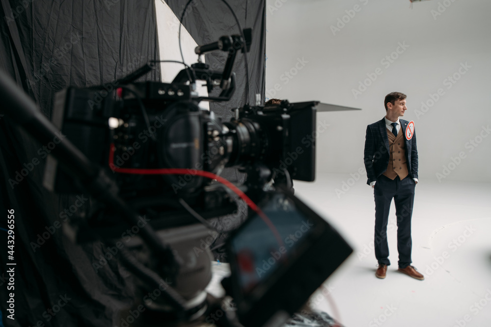 Professional male actor works in the frame on the set. Shooting with a ...