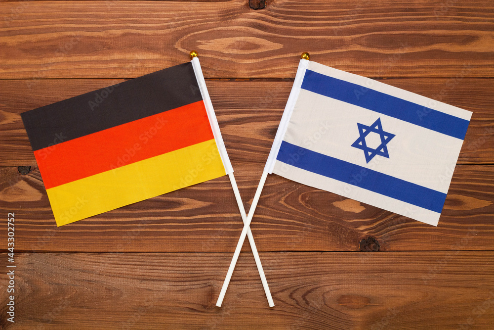Flag of Germany and flag of Israel crossed with each other. The image ...