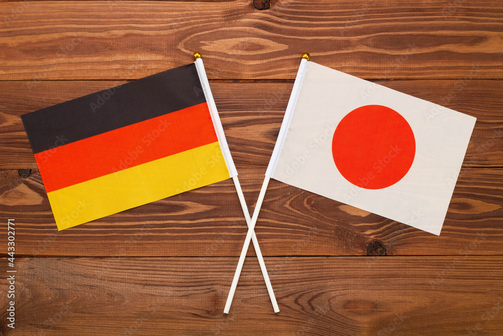 Flag of Germany and flag of Japan crossed with each other. The image ...