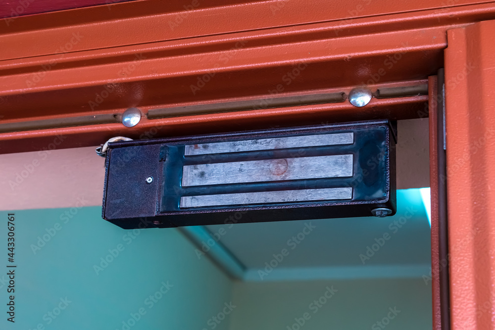 An electric magnet on the front door from above. Stock Photo | Adobe Stock