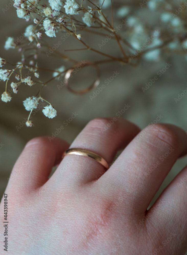 A touching, romantic photo of a woman's hand with a gold wedding ring ...