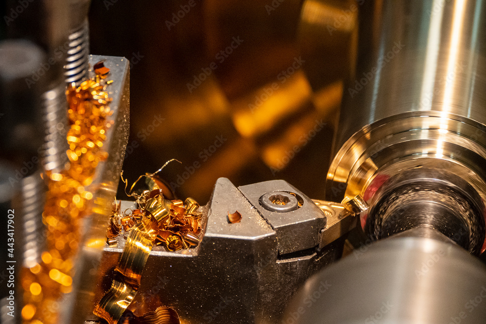 The close-up scene of lathe machine finish cut process the brass shaft ...