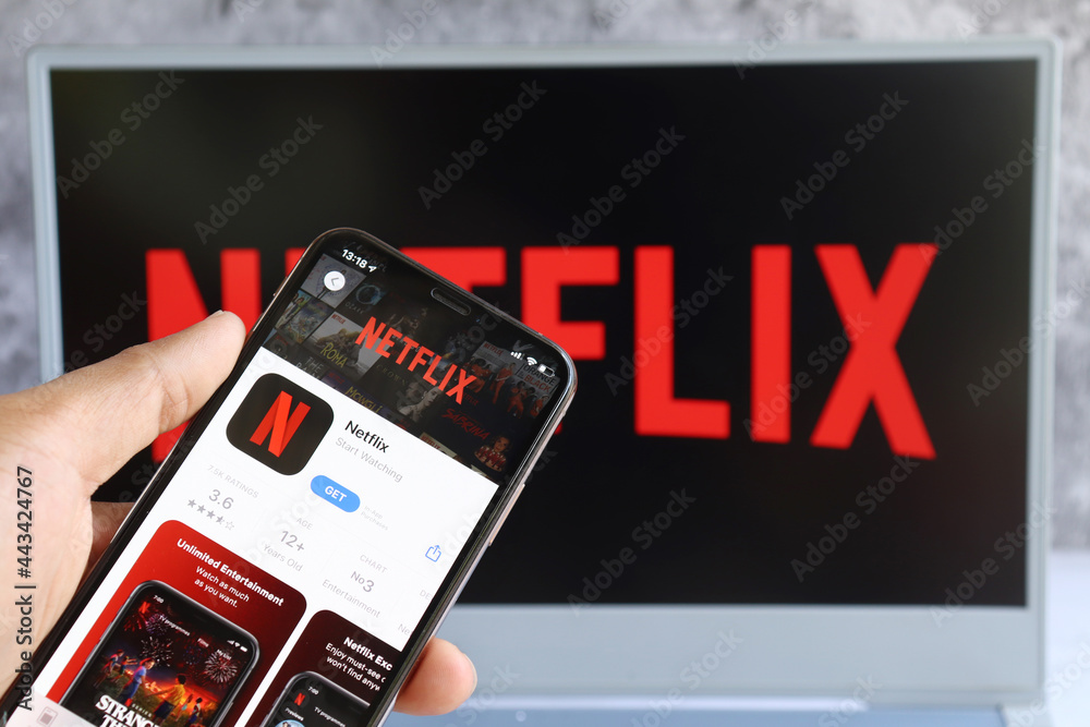 Netflix logo on computer screen and Netflix logo on smartphone screen ...