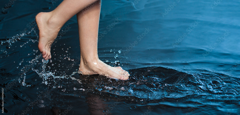 Woman foot step on blue Water in Splash Stock Photo | Adobe Stock