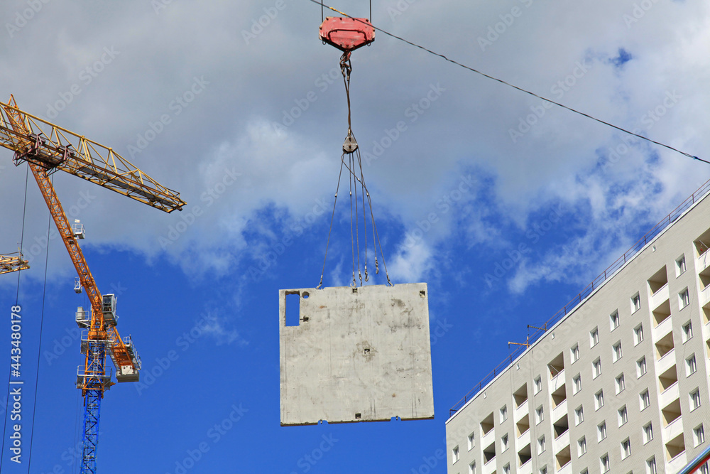 Construction site. Reinforced concrete slab lifted by a crane for the ...