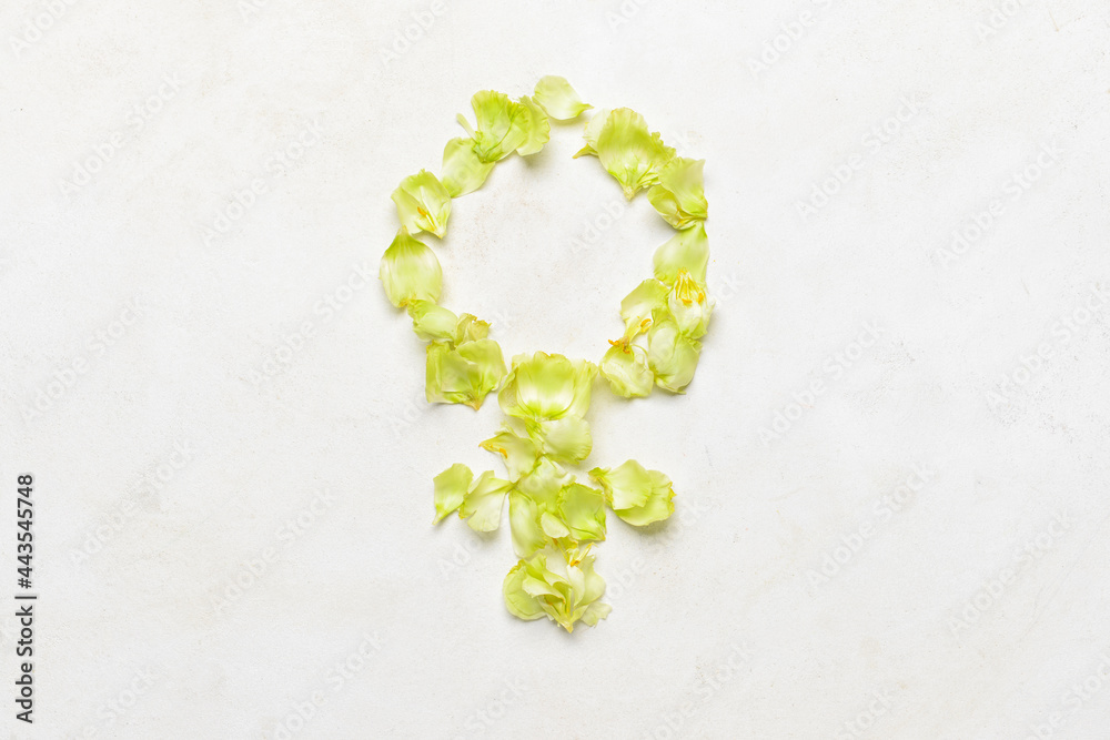Female symbol made of flower petals on white background Stock Photo ...
