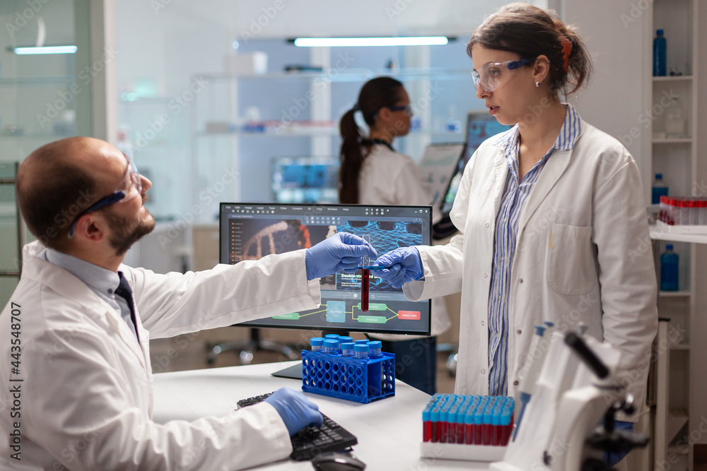 Biochemistry reserarchers doing experiments with blood sample for ...